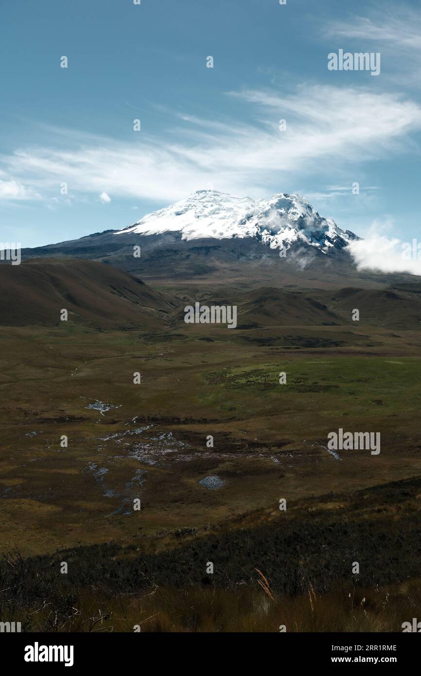 Picturesque landscape of Antisana volcano against blue sky with fluffy ...
