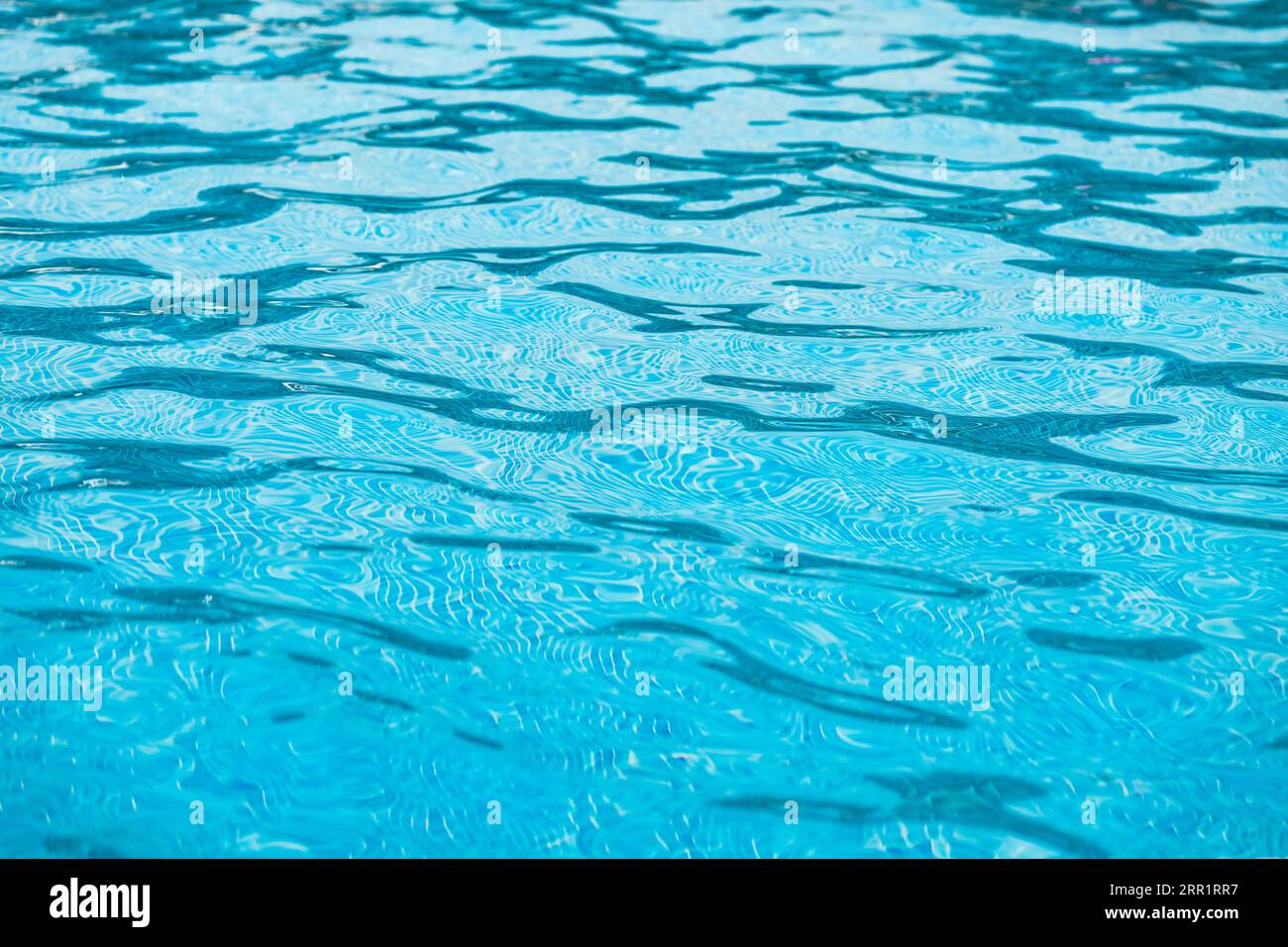 From above abstract background of rippling blue water in swimming pool ...