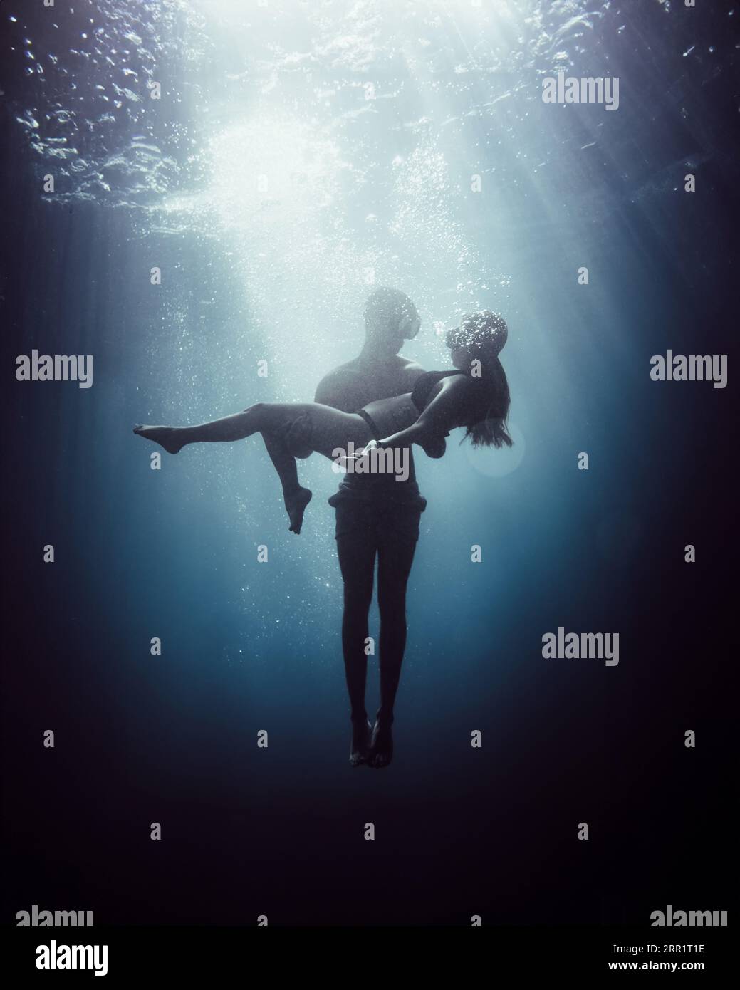 Full body underwater view of unrecognizable romantic young male diver ...