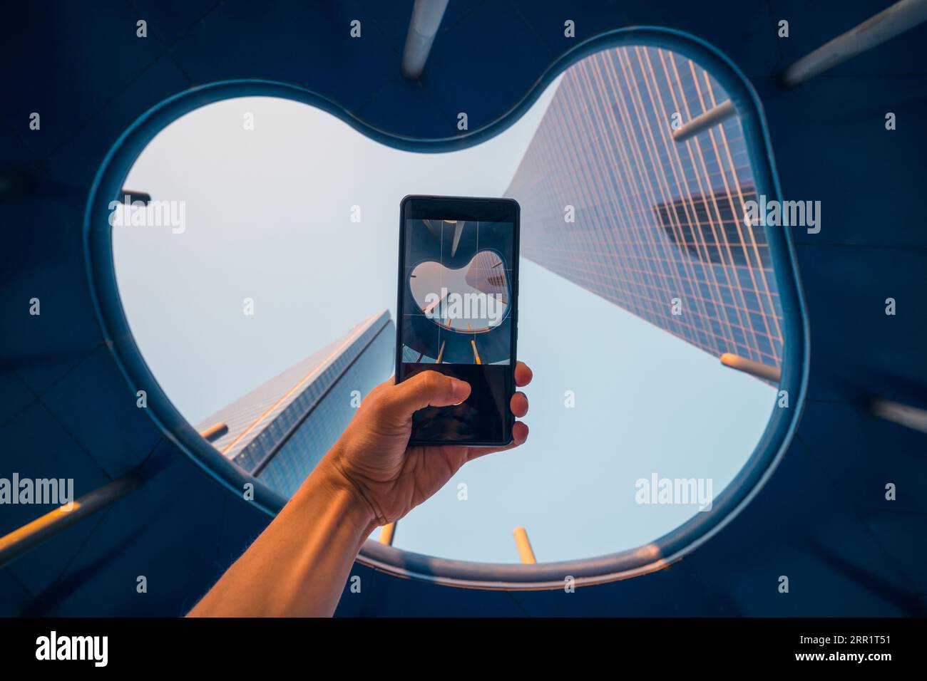 From below of anonymous person with mobile phone while aiming at open ...