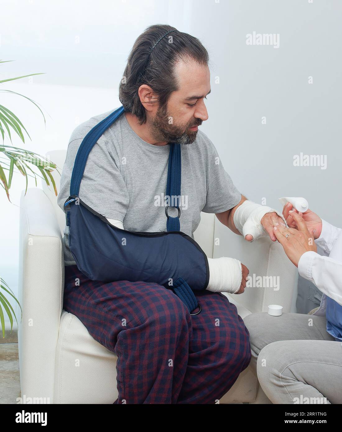 Cropped unrecognizable female nurse applying antibiotic on wound before ...