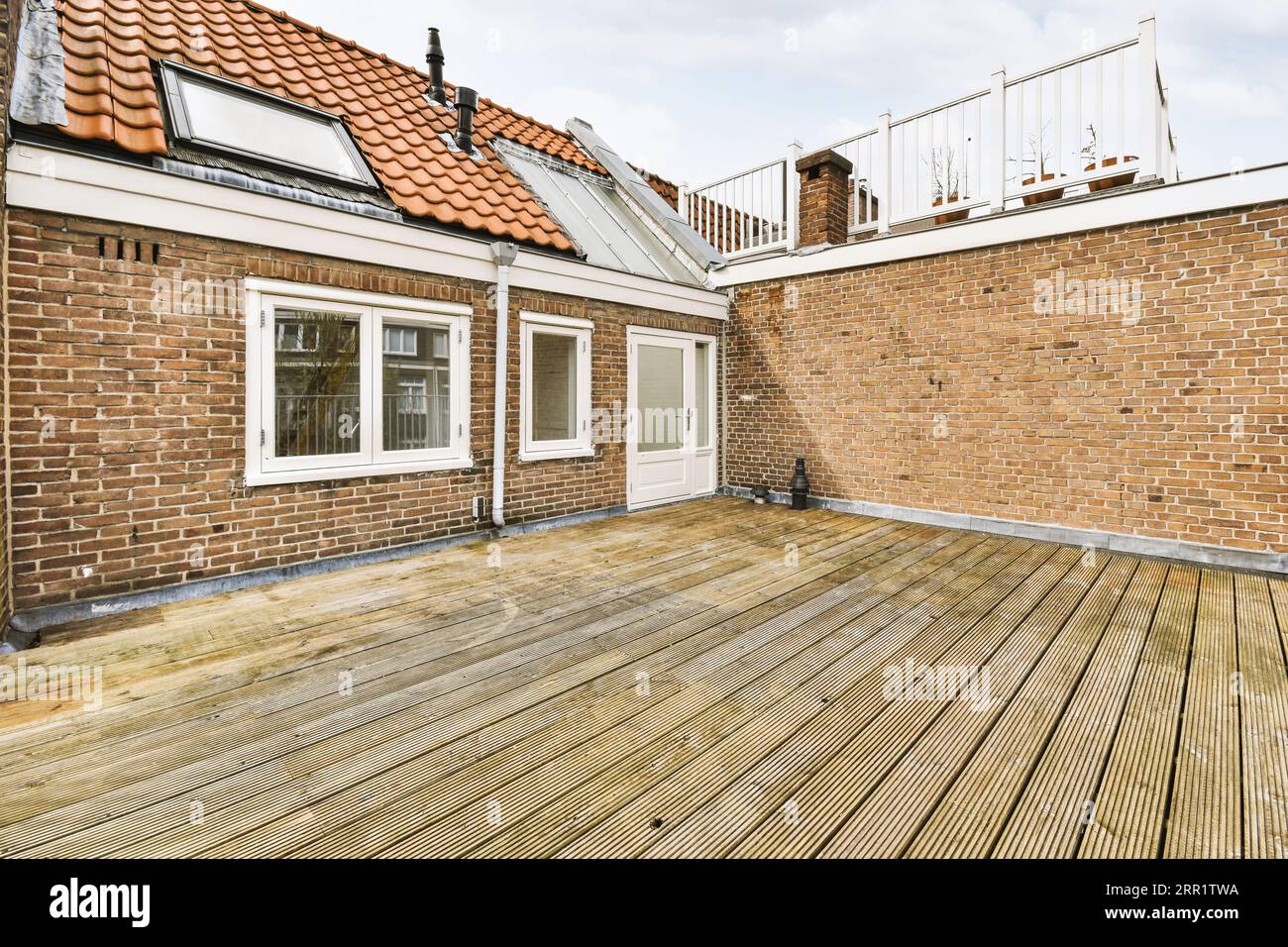 Bright brick balcony with metal railings and door Stock Photo - Alamy