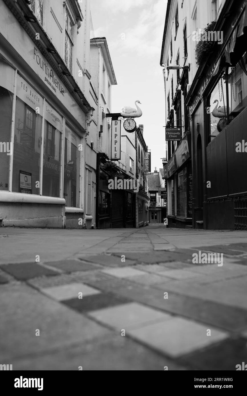A vertical of a street Norwich City center in UK in grayscale Stock ...