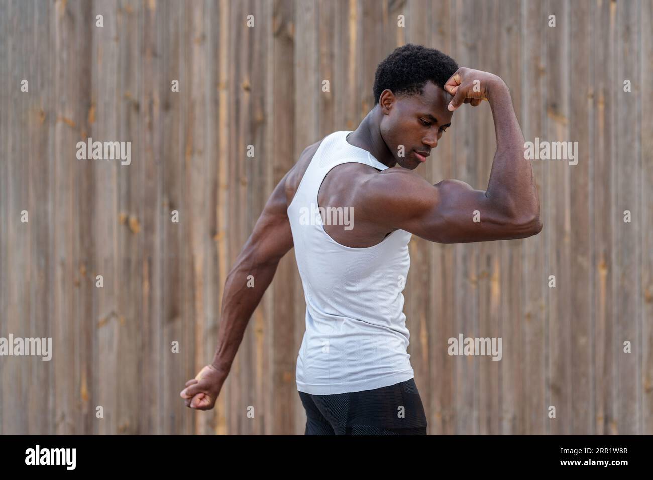 Side view of confident muscular African American male bodybuilder in ...