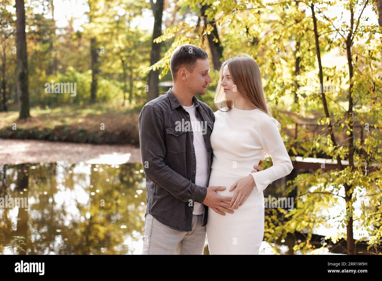 Family day. Stylish marriage pregnant couple waiting for baby. Man is ...