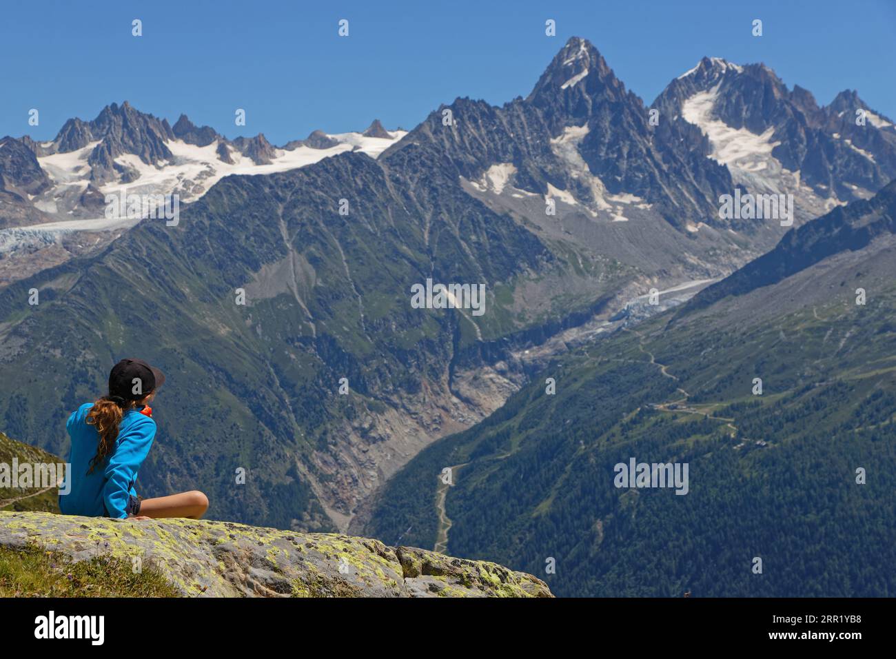 CHAMONIX, FRANCE, July 8, 2022 : Young hiker looks at mountains around ...