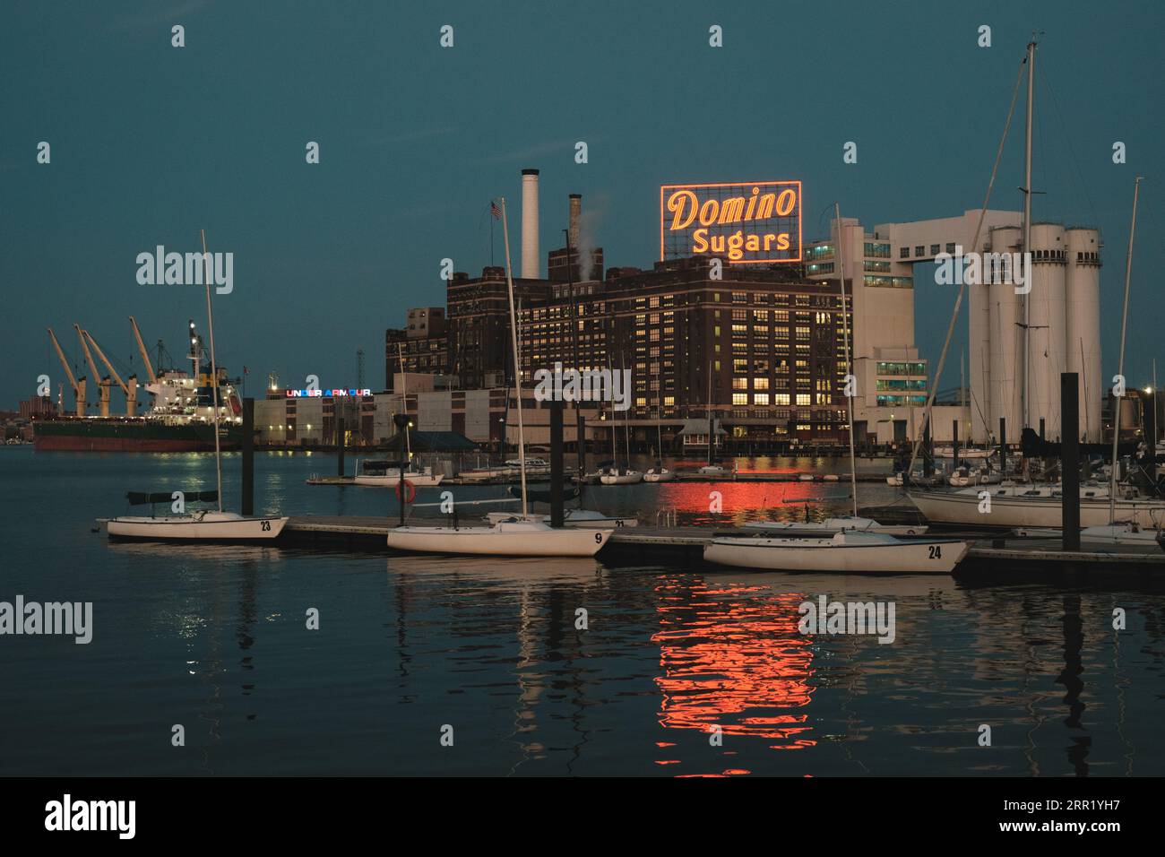 Domino Sugars Factory vintage neon sign and the harbor at night in ...