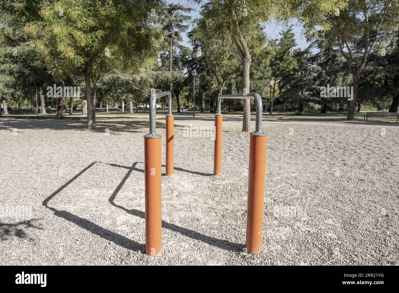 Some metal parallel bars in an urban park for the enjoyment of users ...