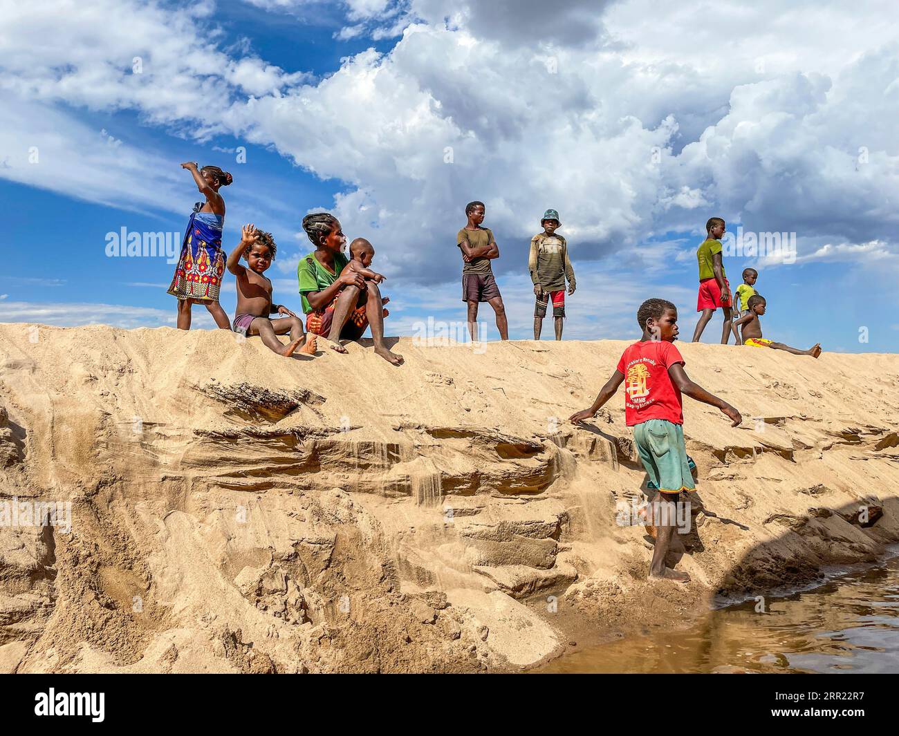 Madagascar, Tsiribihina river, group of children on the sandy banks of ...