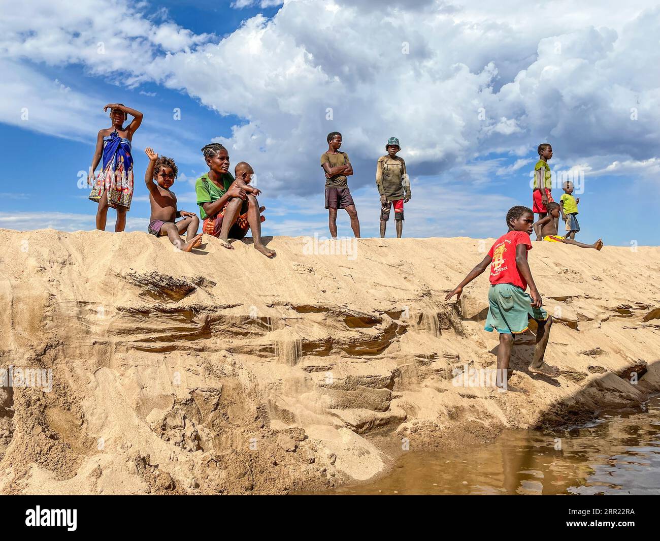 Madagascar, Tsiribihina river, group of children on the sandy banks of ...