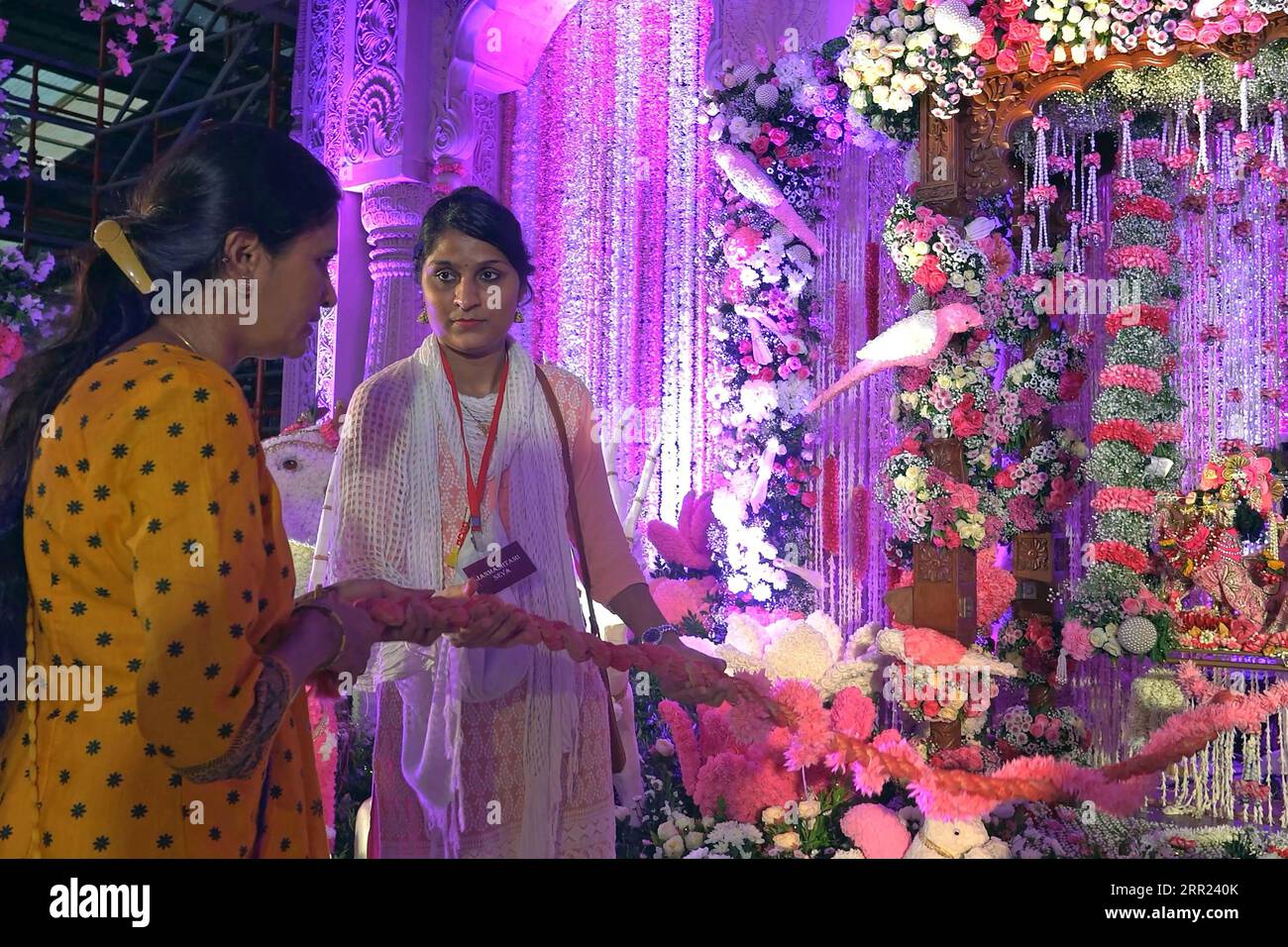 Hare Krishna devotees queue to pray in front of an altar at ISCKON ...