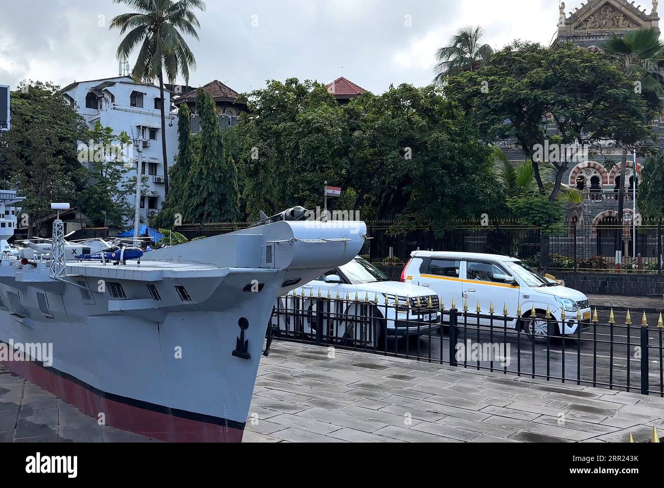 Cars pass by a large naval ship model in Kala Ghoda district in Mumbai ...