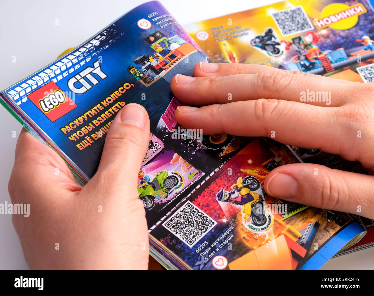 Tambov, Russian Federation - December 21, 2021 A woman opening Lego ...