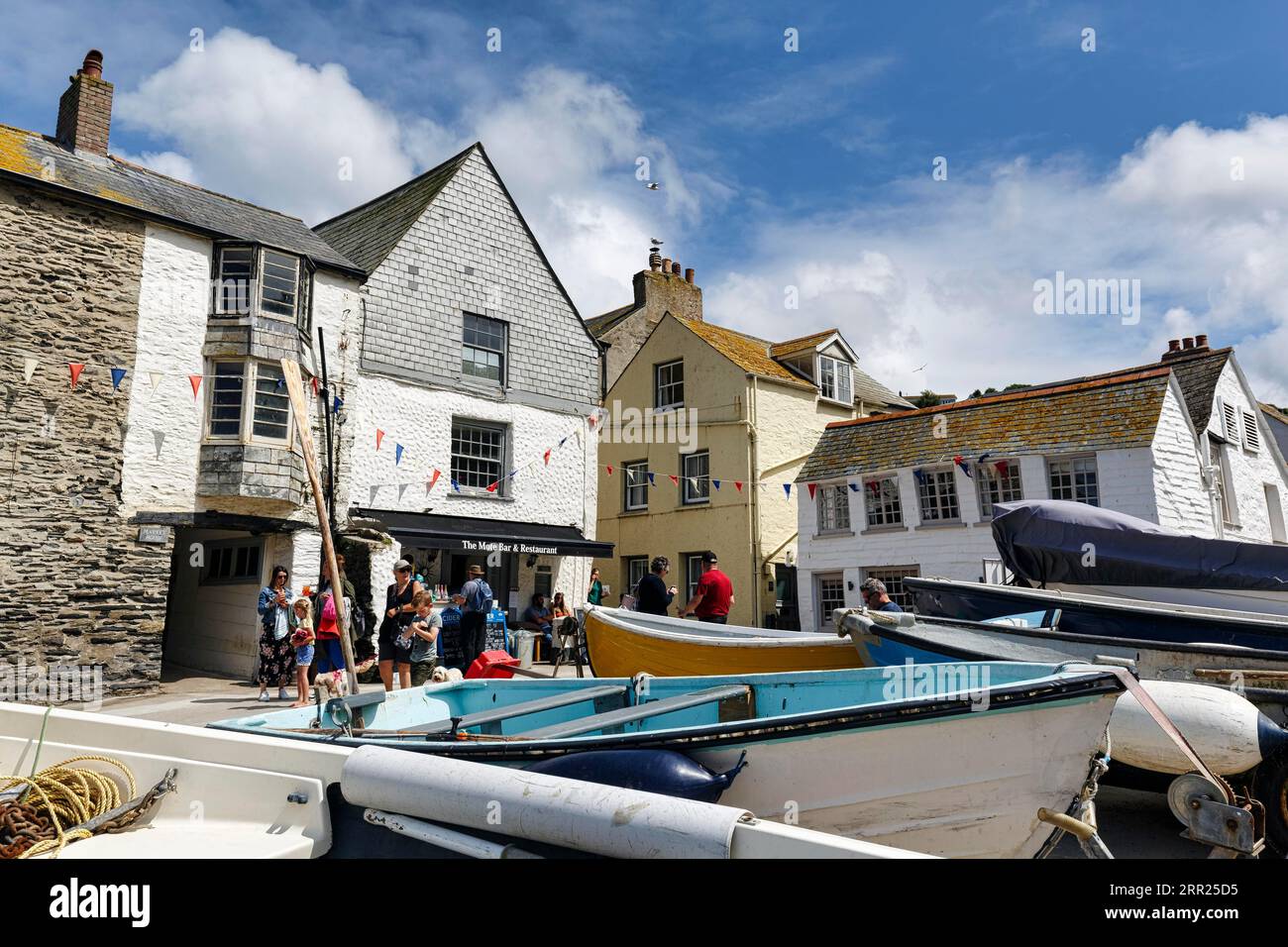 Pedestrians and boats in the harbour, tourists in the fishing village ...
