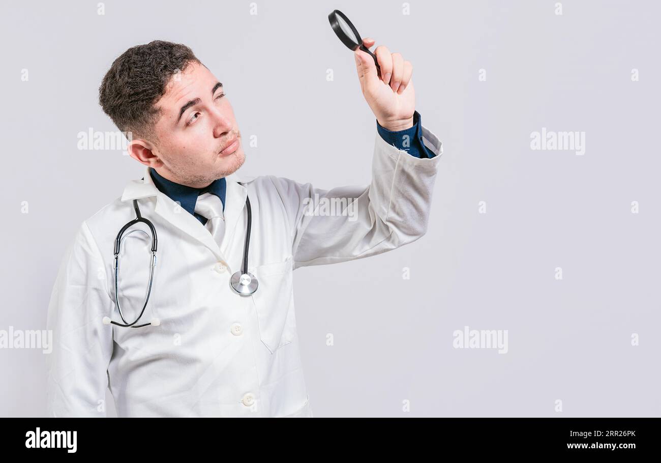 Doctor looking for something with magnifying glass looking isolated ...