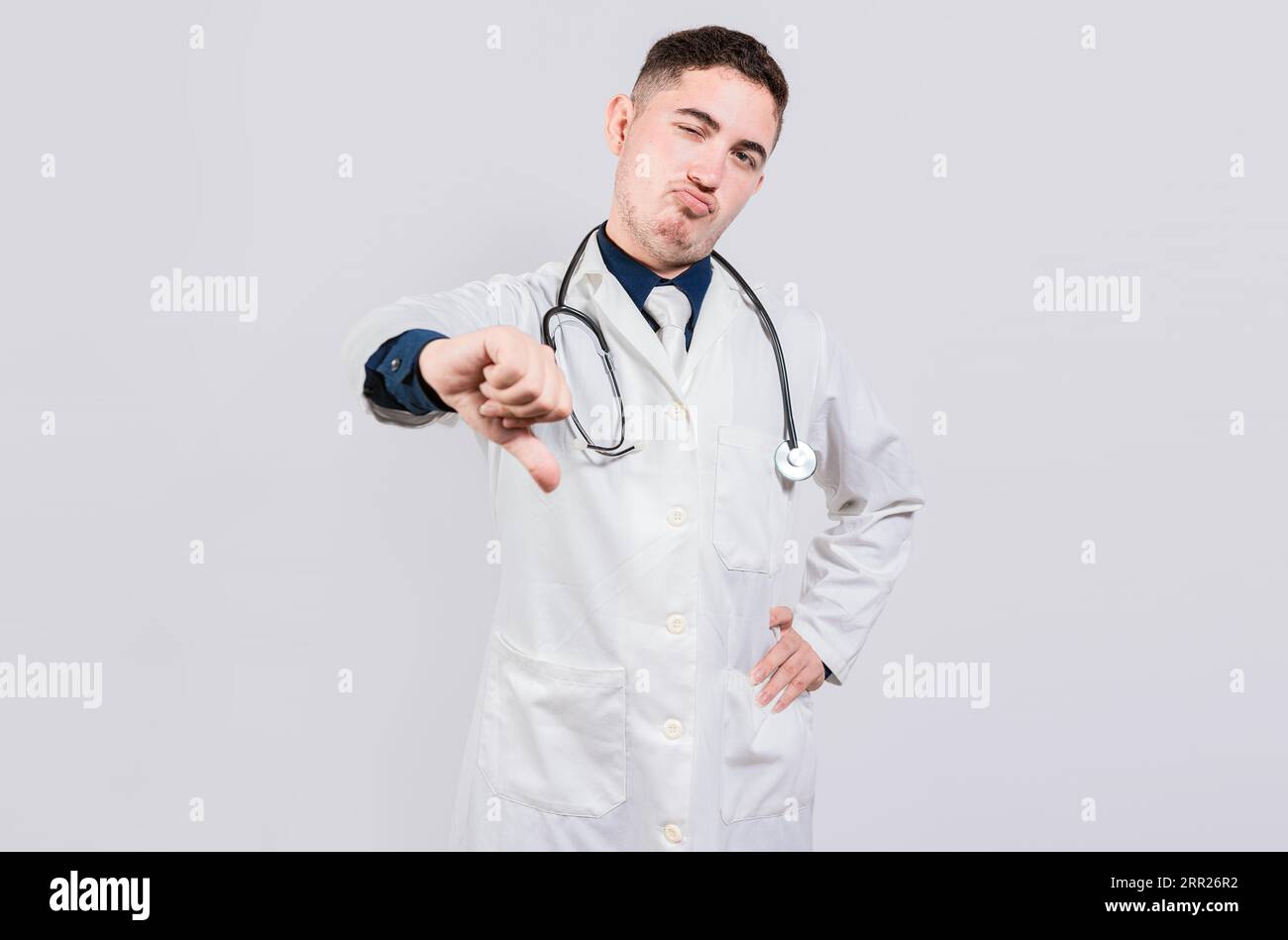 Doctor gesturing disapproval isolated. Unhappy doctor with thumb down ...