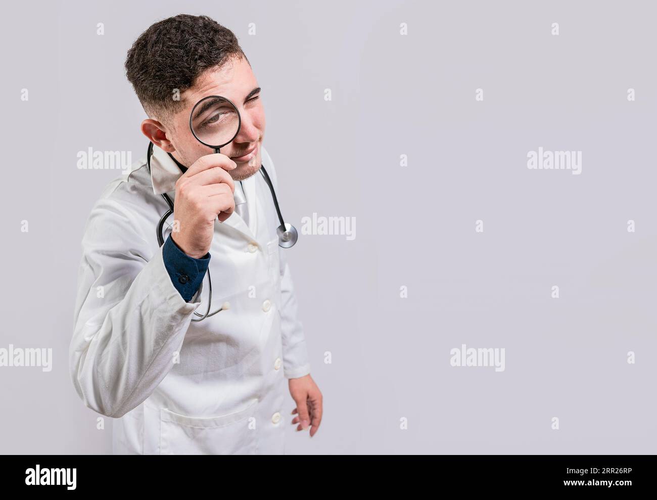 Doctor looking for something with magnifying glass looking isolated ...
