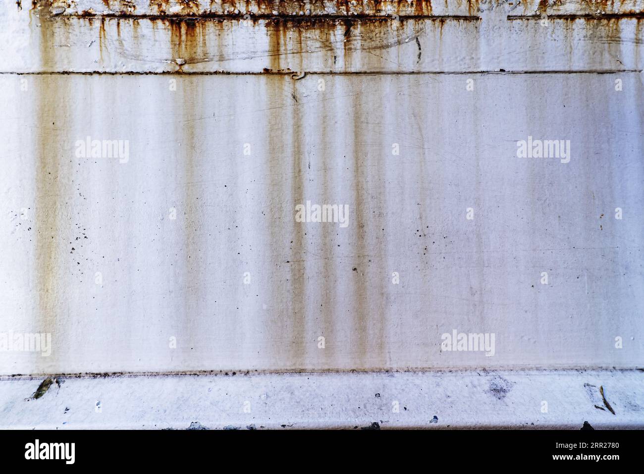 A metal surface exposed to the outside with rust marks left by jets of ...