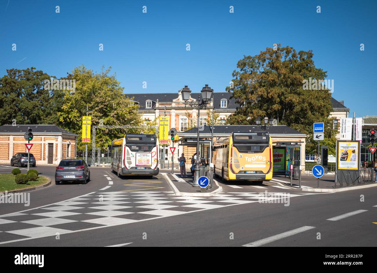 Public single deck buses at bus stops outside the Espace Argence ...