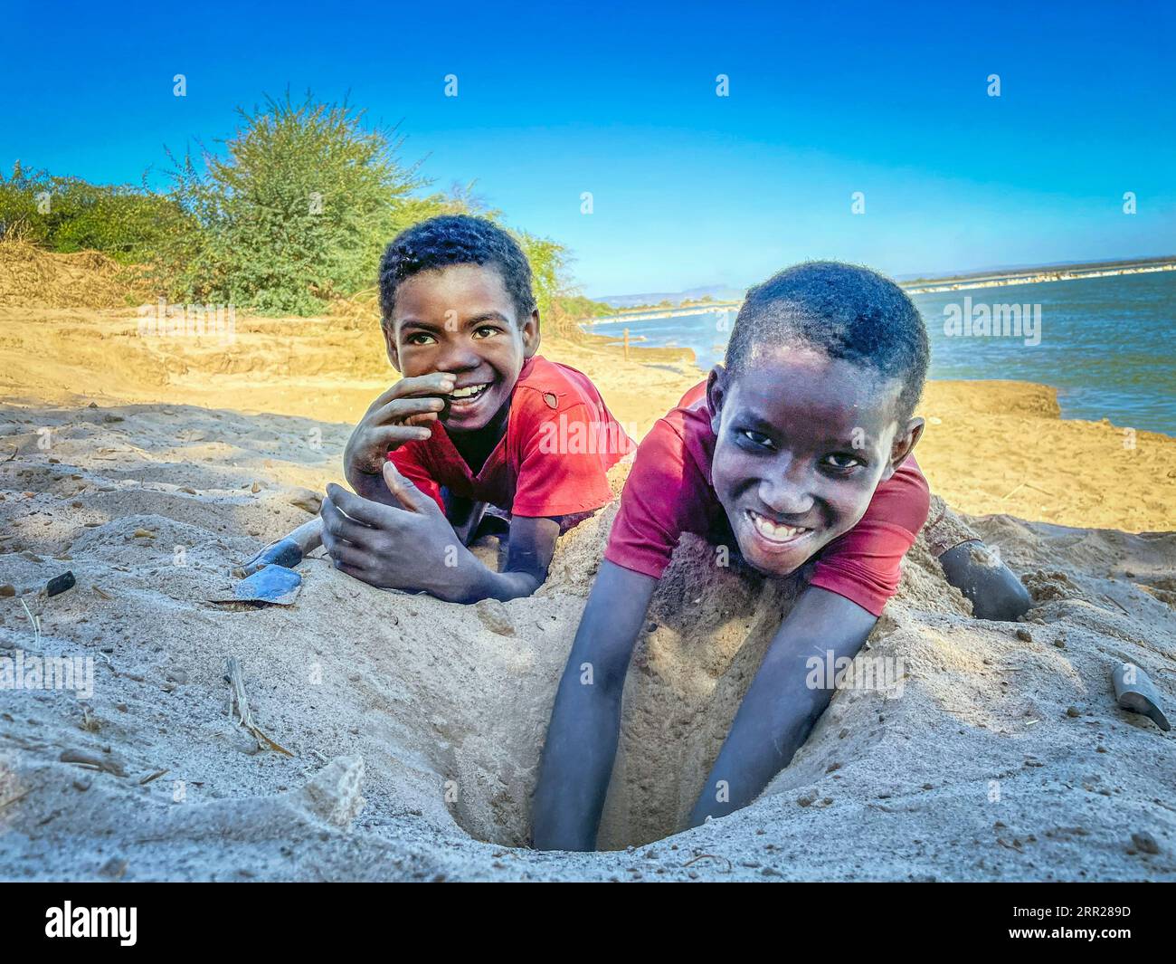 Madagascar, Tsiribihina river, children play on the banks of the river ...
