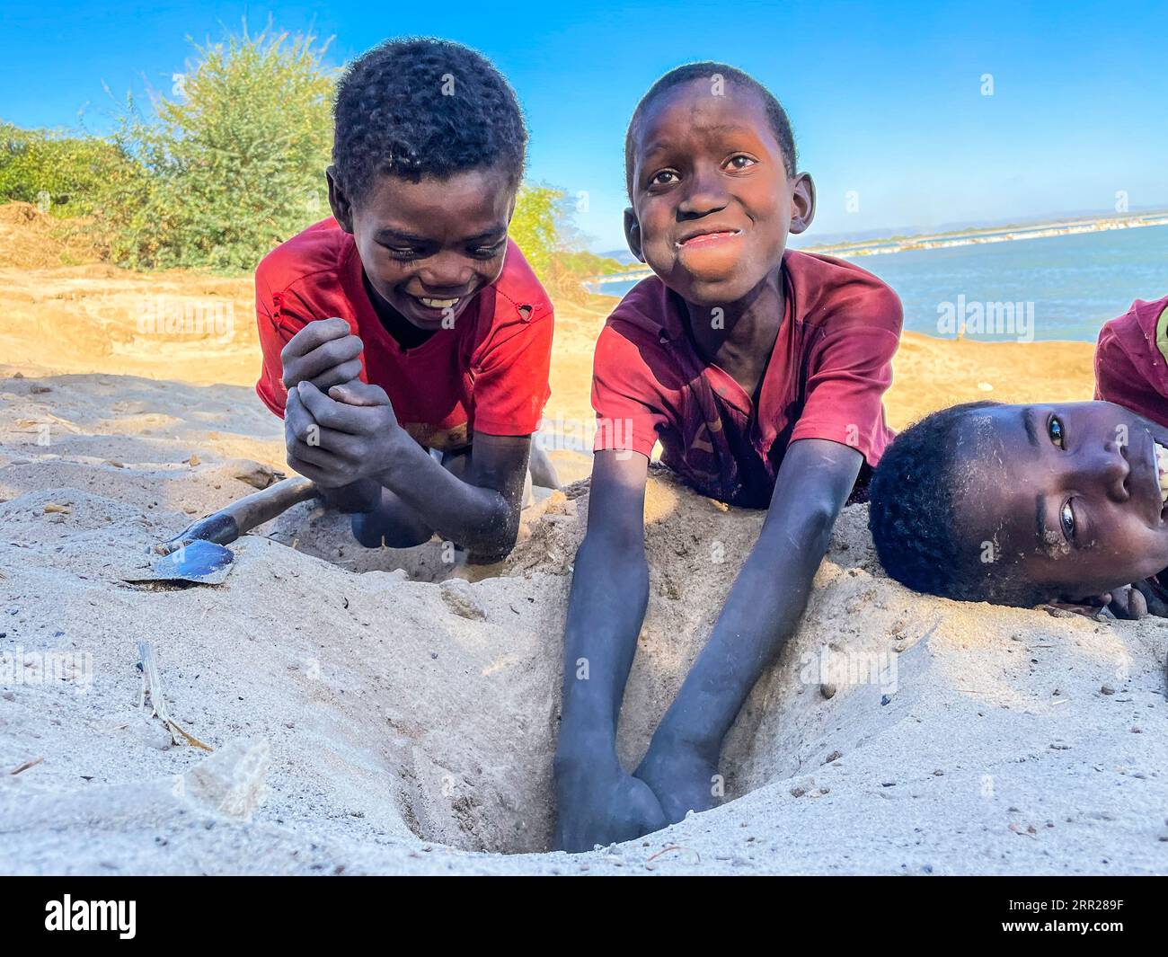 Madagascar, Tsiribihina river, children play on the banks of the river ...