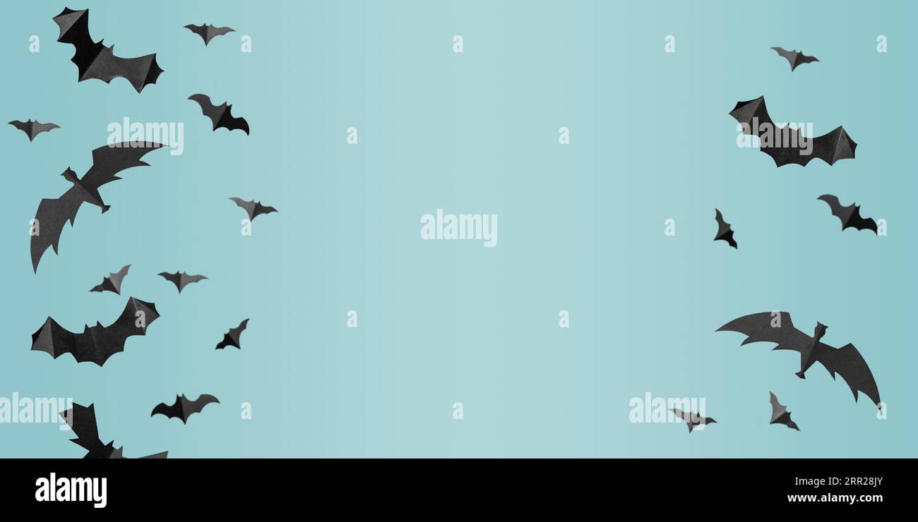 Halloween concept. Black papercraft flying bats on blue. Flat lay and ...