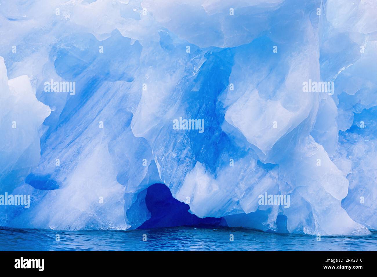 Ice cave in a iceberg floating in the sea at arctic, Svalbard Stock ...