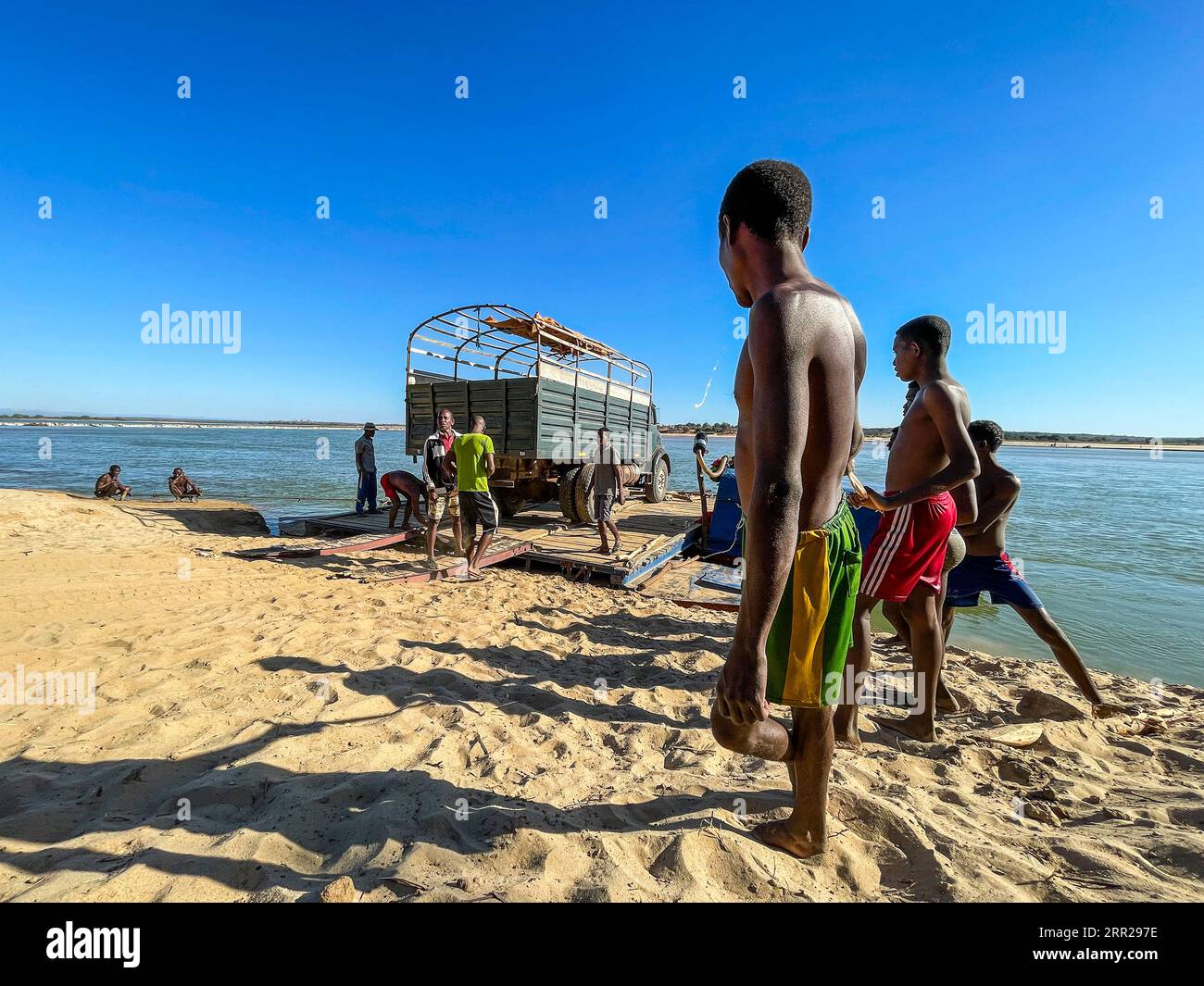 Madagascar, Tsiribihina river, young men tow barge on river Stock Photo ...