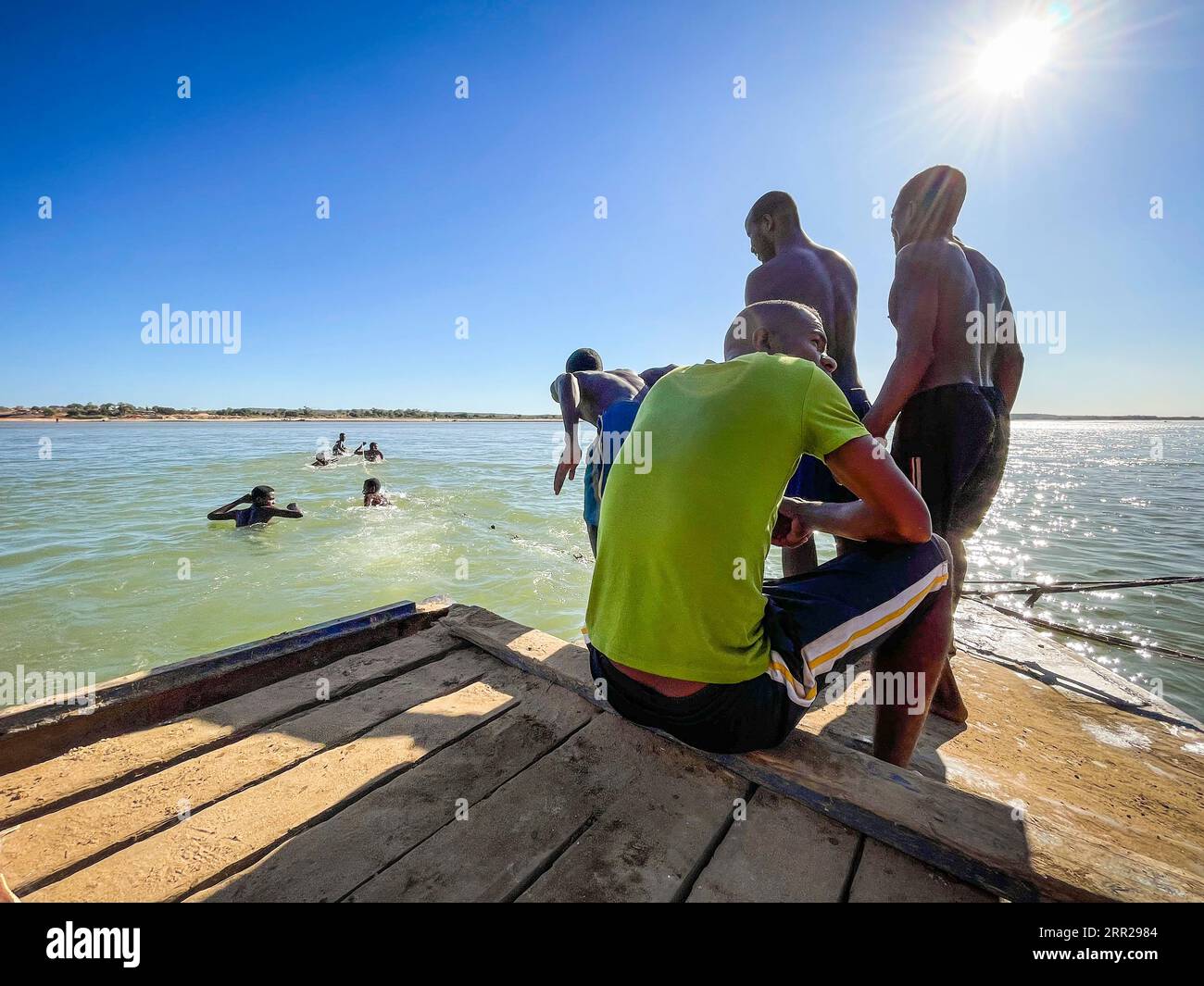 Madagascar, Tsiribihina river, young men tow barge on river Stock Photo ...