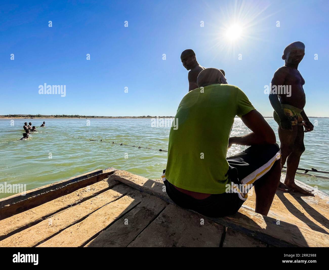 Madagascar, Tsiribihina river, young men tow barge on river Stock Photo ...