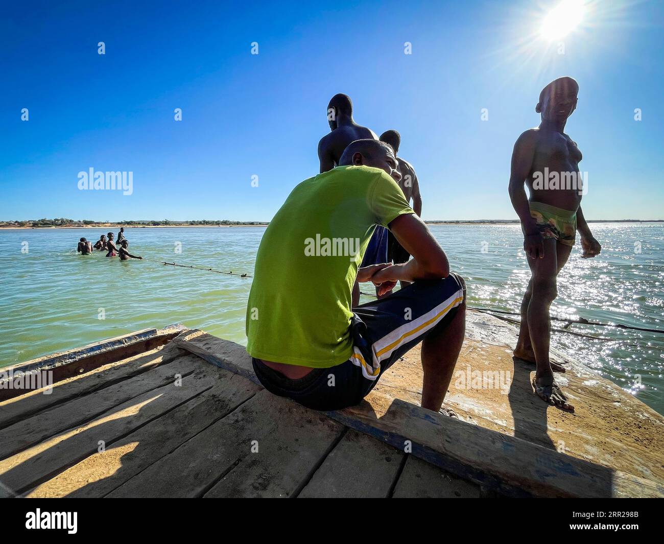 Madagascar, Tsiribihina river, young men tow barge on river Stock Photo ...
