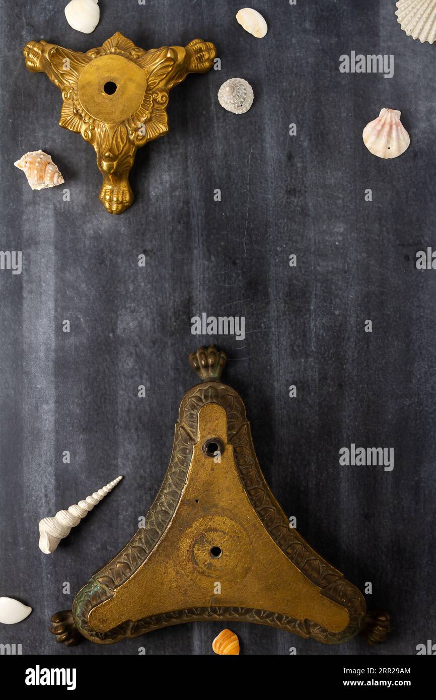 Two antique ornate cast brass electric lamp bases on black background ...