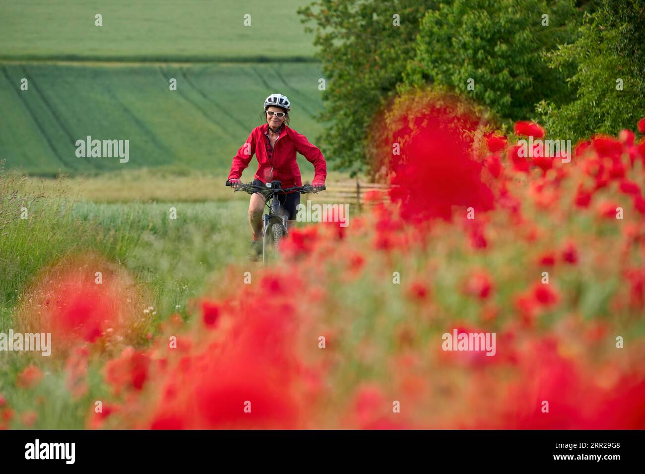 Nice, active senior citizen, riding her electric bike in a huge field ...