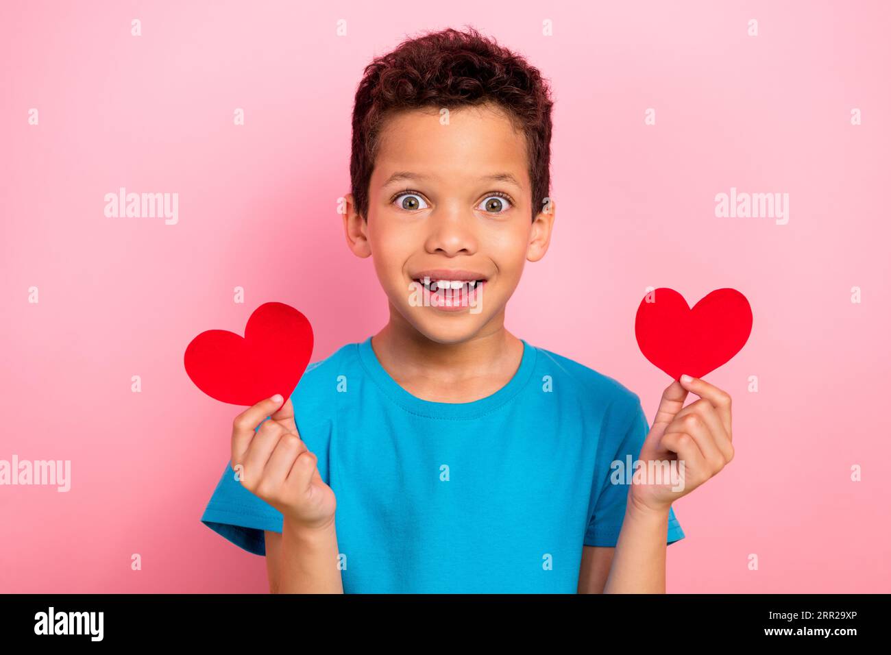 Photo portrait of сute little boy excited hold two red postcards date ...