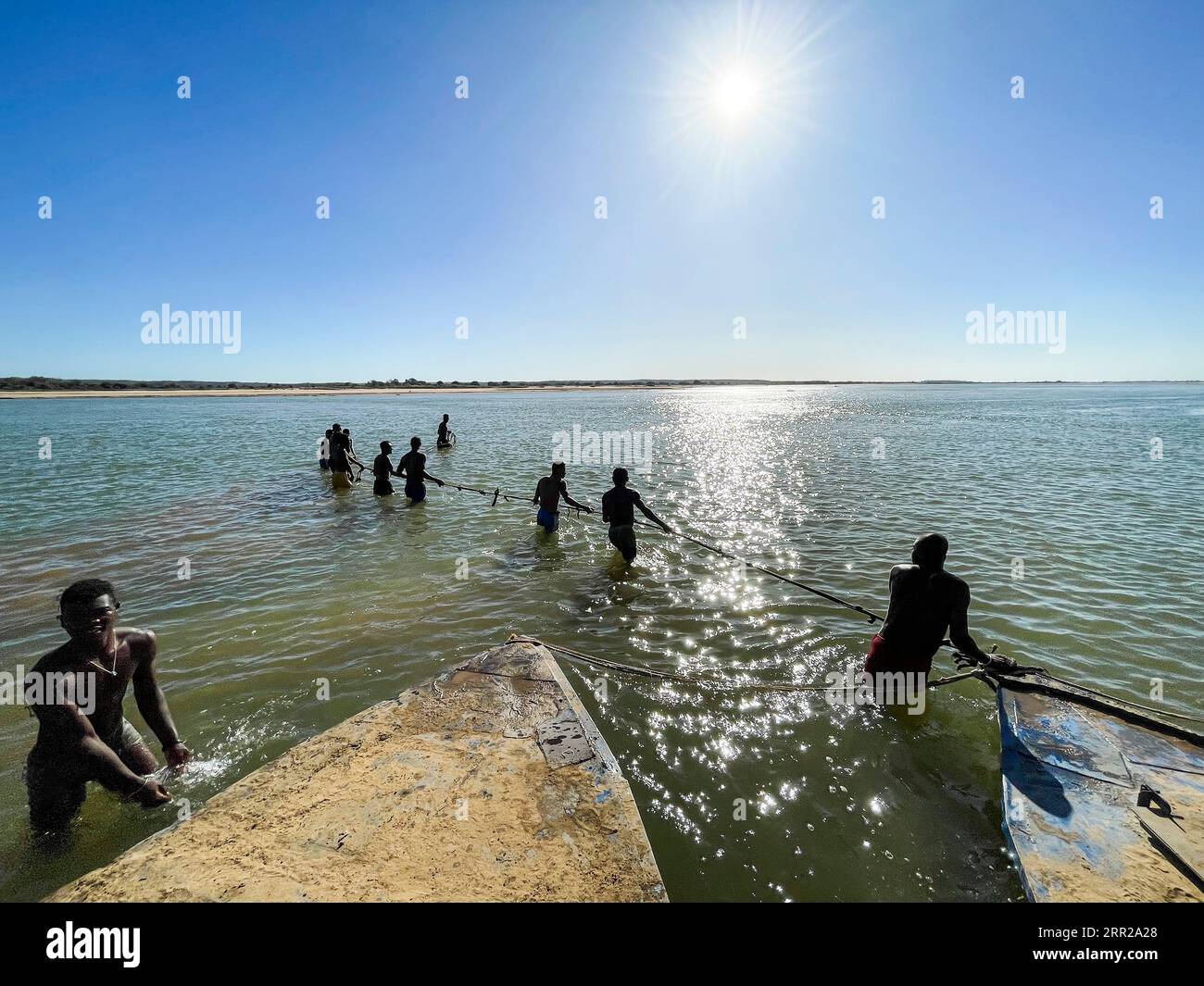 Madagascar, Tsiribihina river, young men tow barge on river Stock Photo ...