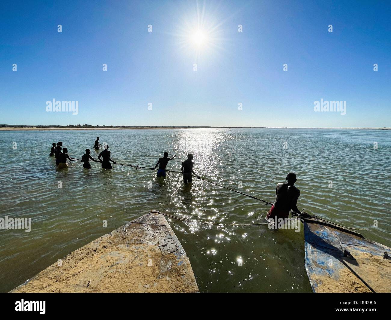 Madagascar, Tsiribihina river, young men tow barge on river Stock Photo ...