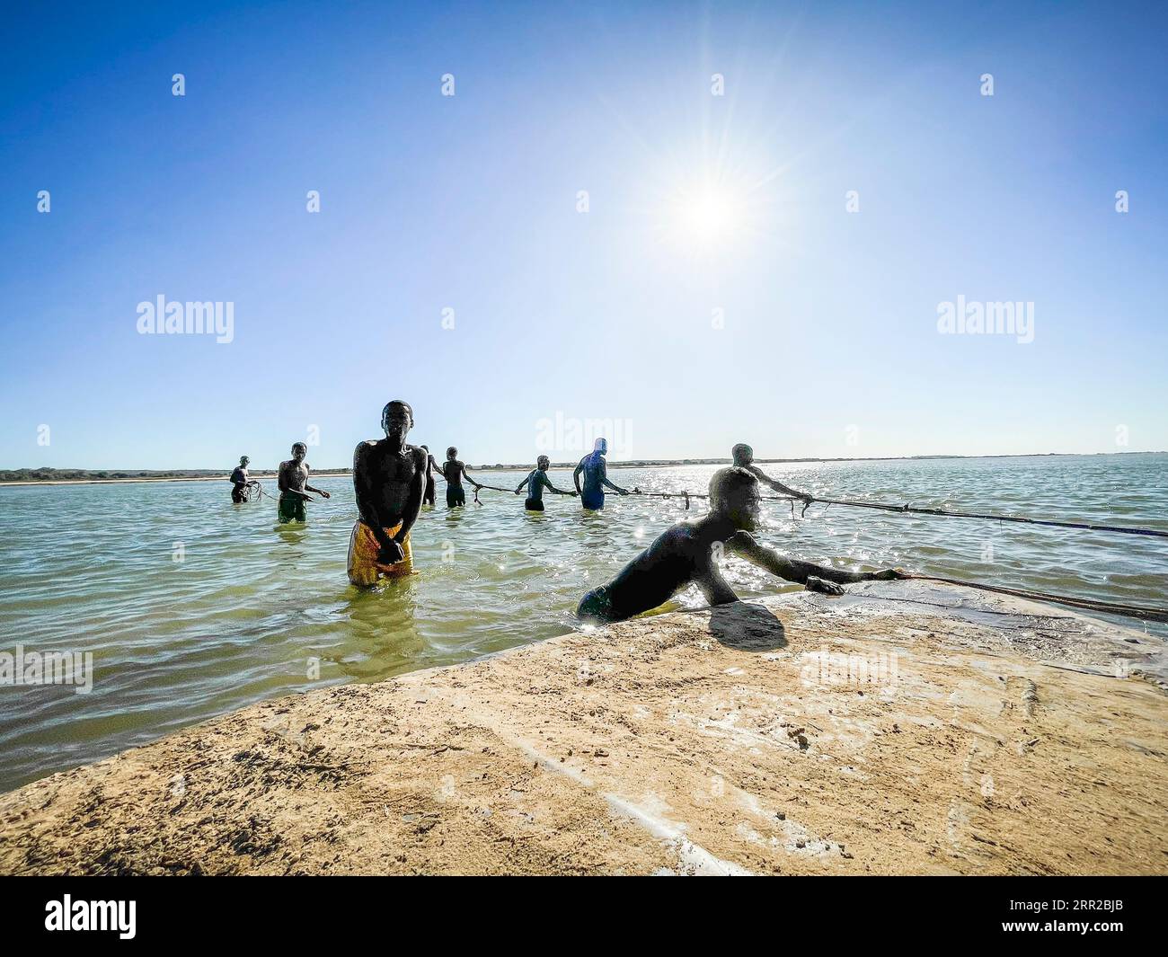 Madagascar, Tsiribihina river, young men tow barge on river Stock Photo ...