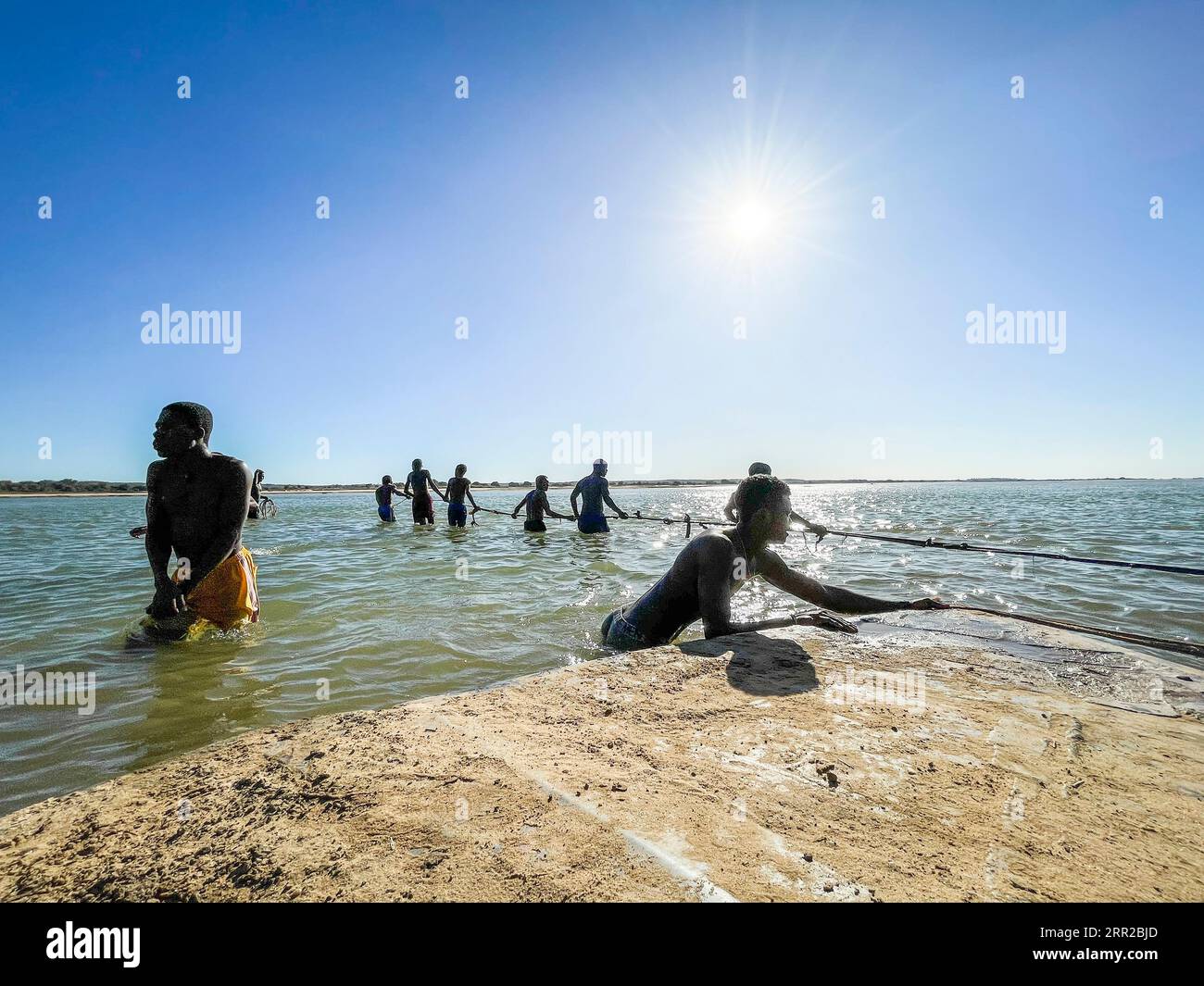Madagascar, Tsiribihina river, young men tow barge on river Stock Photo ...