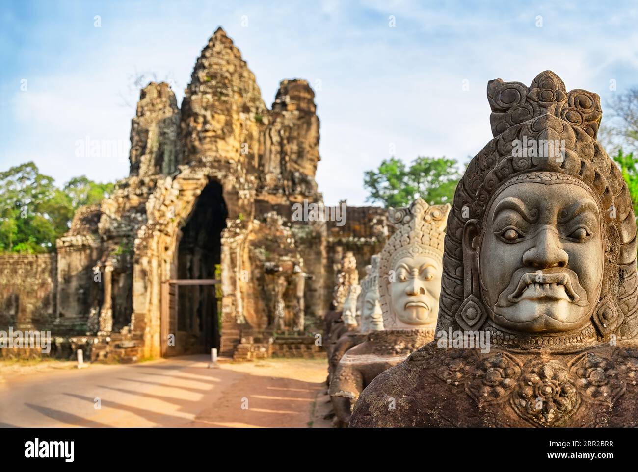 South gate to Angkor Thom in Cambodia is lined with warriors and demons ...