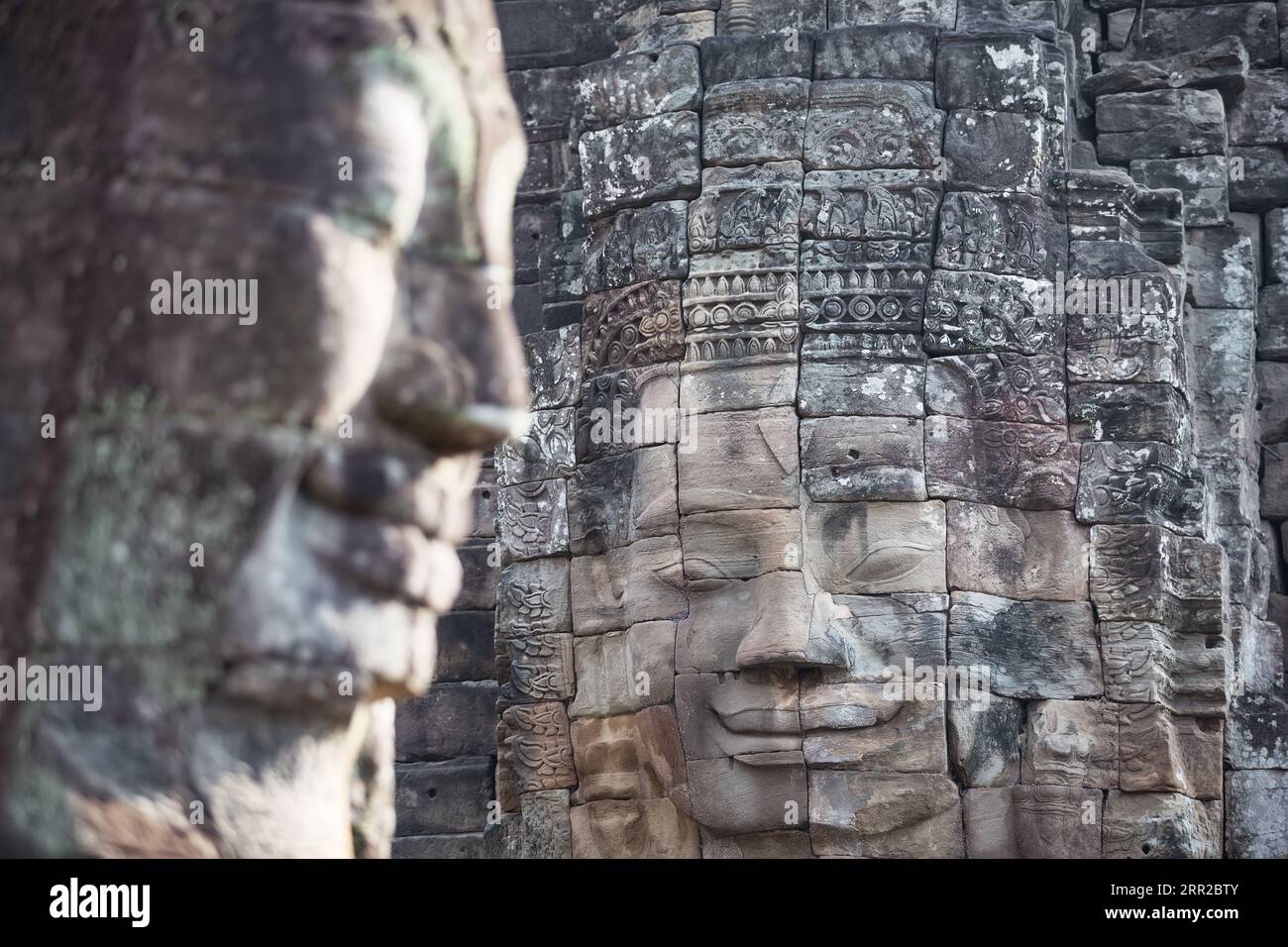 Giant stone faces of ancient Bayon temple. The stone faces of the khmer ...