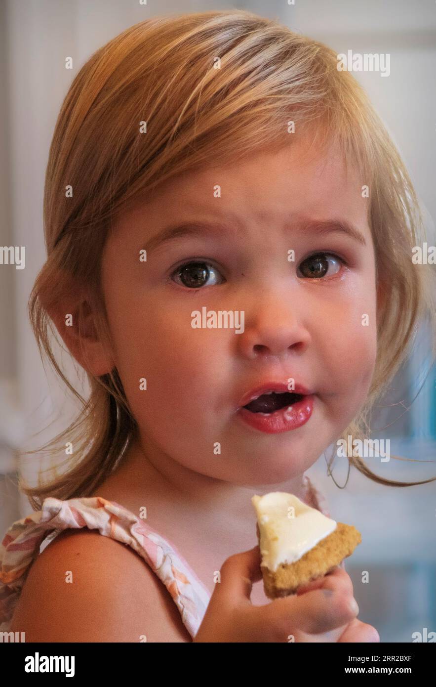 A young girl enjoying a snack Stock Photo - Alamy