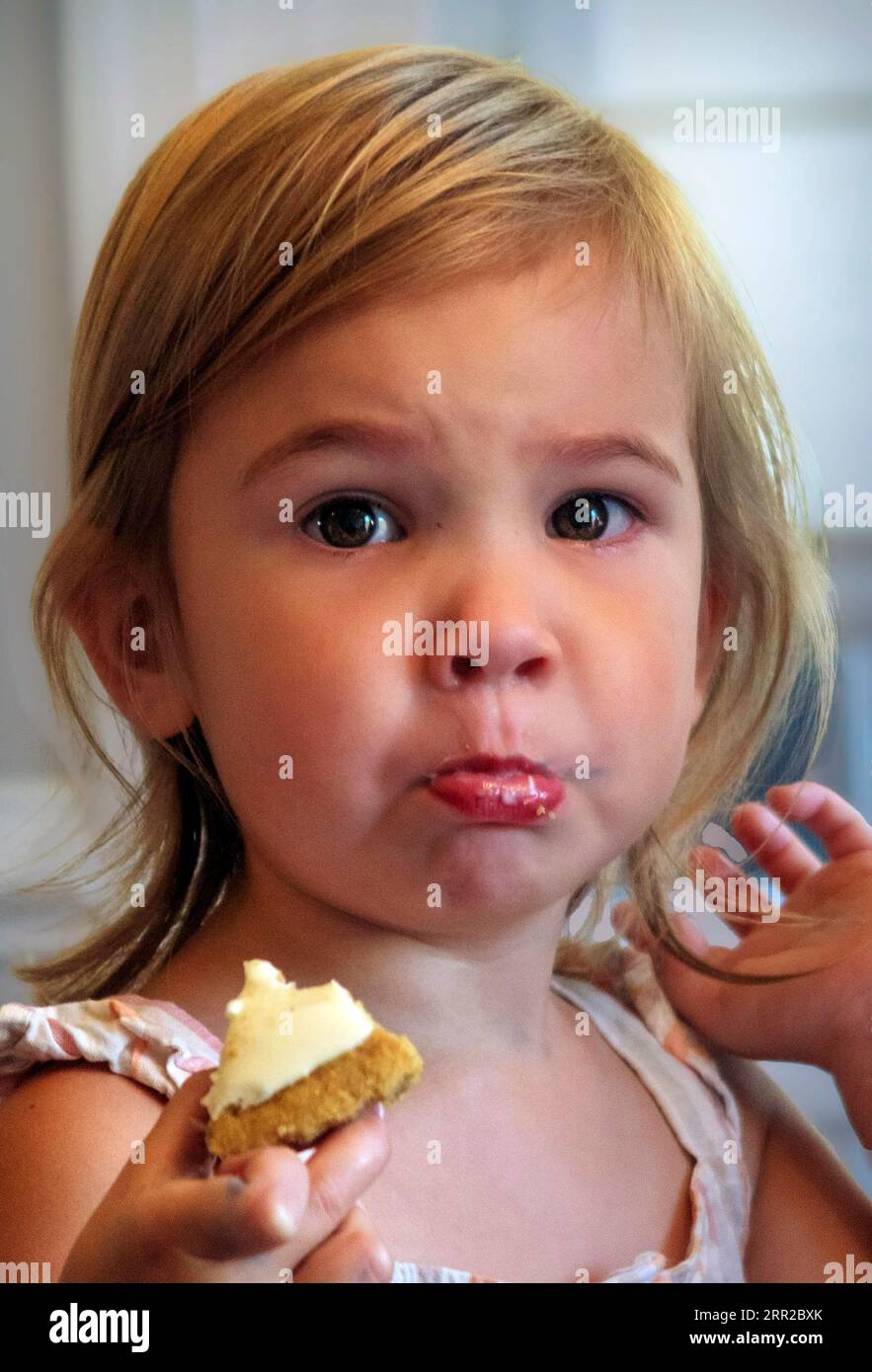 A young girl enjoying a snack Stock Photo - Alamy