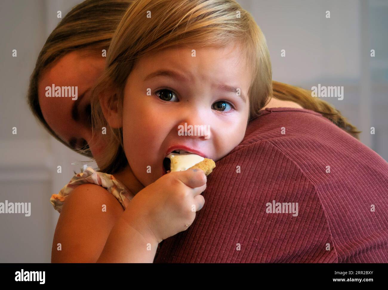 A young girl enjoying a snack Stock Photo - Alamy