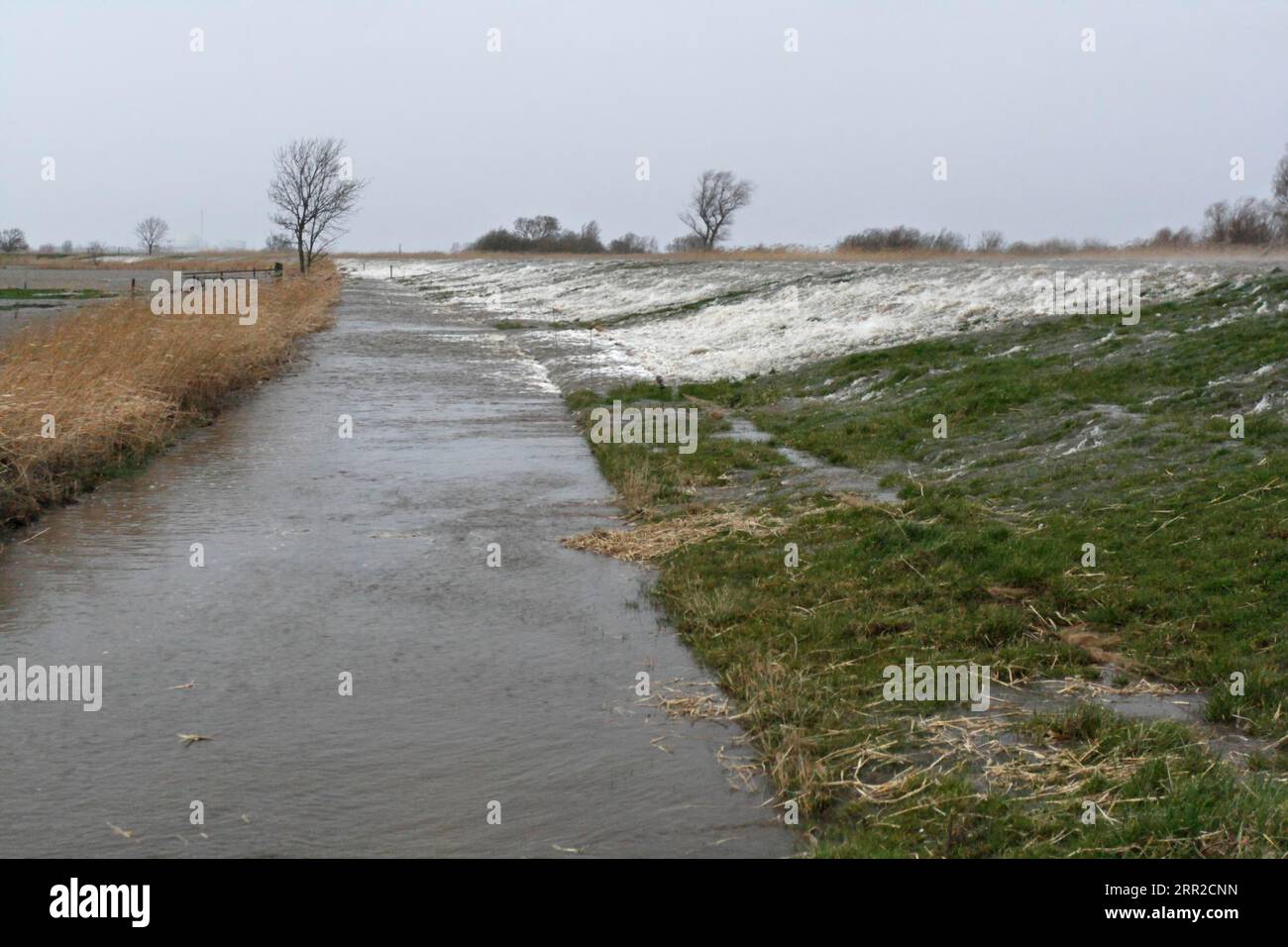 Overtopping of the dike during a storm surge on the Lower Weser island ...