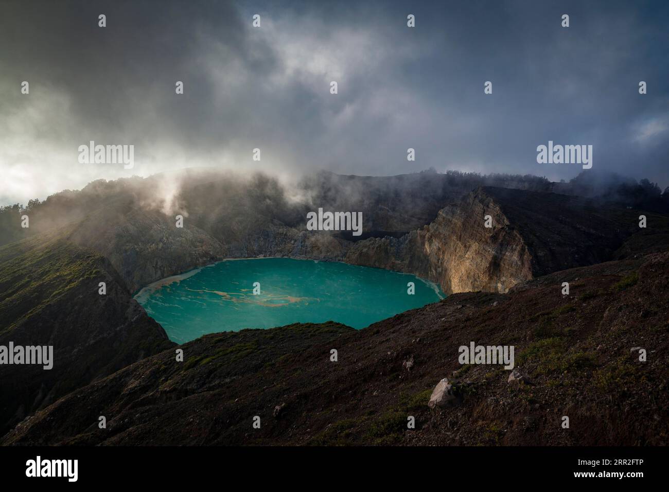 Fog over crater with turquoise crater lake, Kelimutu Volcano, Kelimutu ...