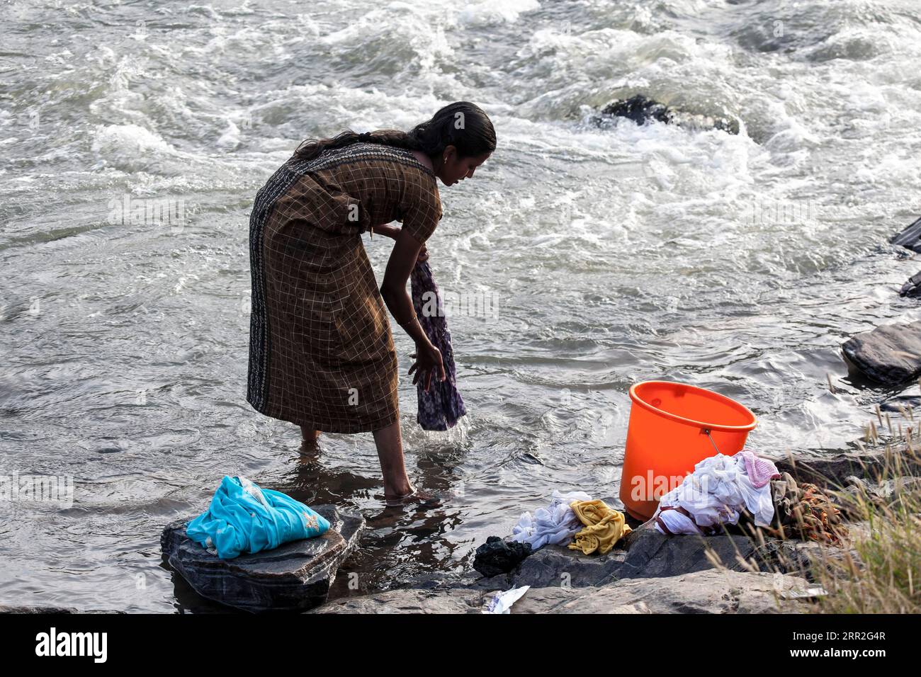 Woman washing clothes in the river, South India, India Stock Photo - Alamy