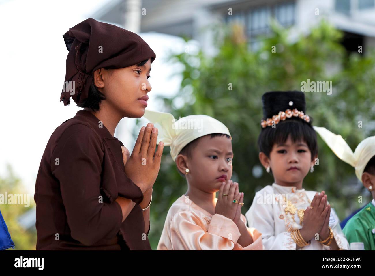 Young woman and children praying, Taungu, Bago Division, Myanmar, Burma ...