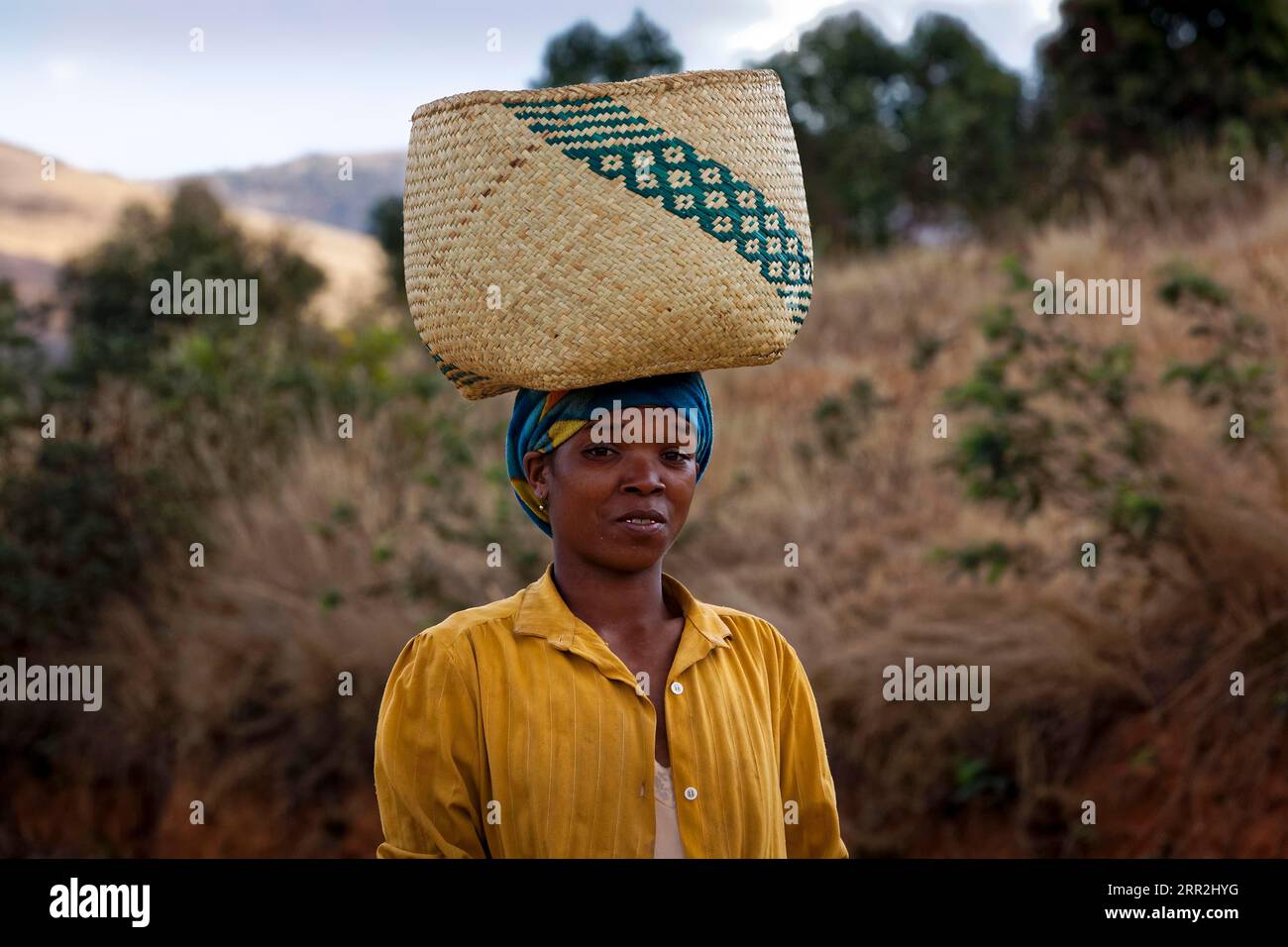 Woman carrying basket on her head, portrait, Madagascar Stock Photo - Alamy