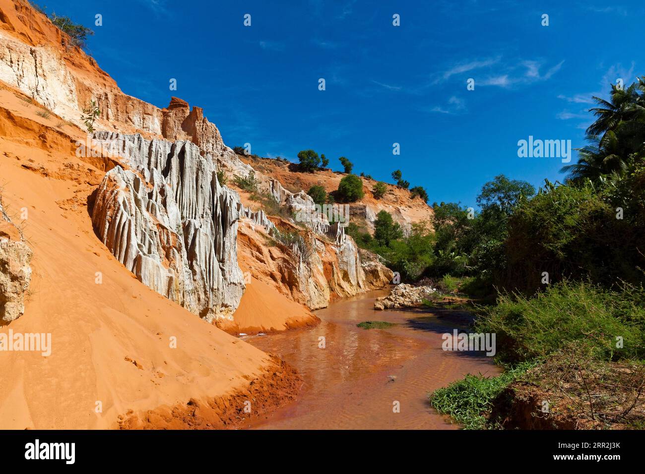 Small river Suoi Tien or Fairy stream by sand dunes and rocks, Mui Ne ...