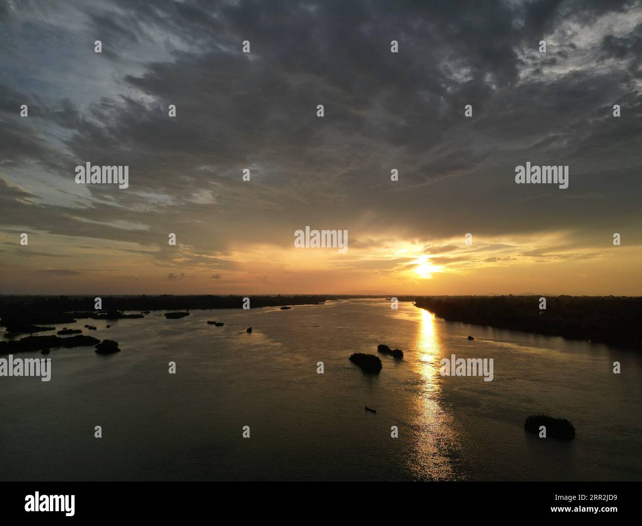 An aerial view of a picturesque sunset sky over the Mekong River in ...